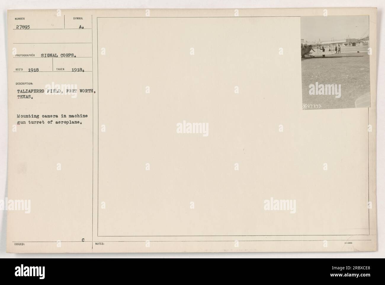 Mounting camera in machine gun turret of an aeroplane at Taliaferro Field in Fort Worth, Texas ...