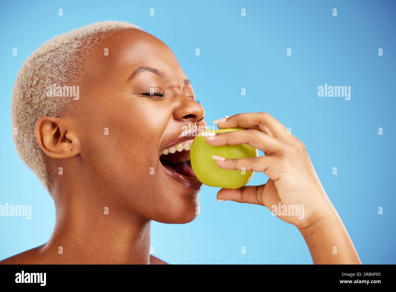 Black woman, apple and bite in diet, nutrition or health and wellness ...