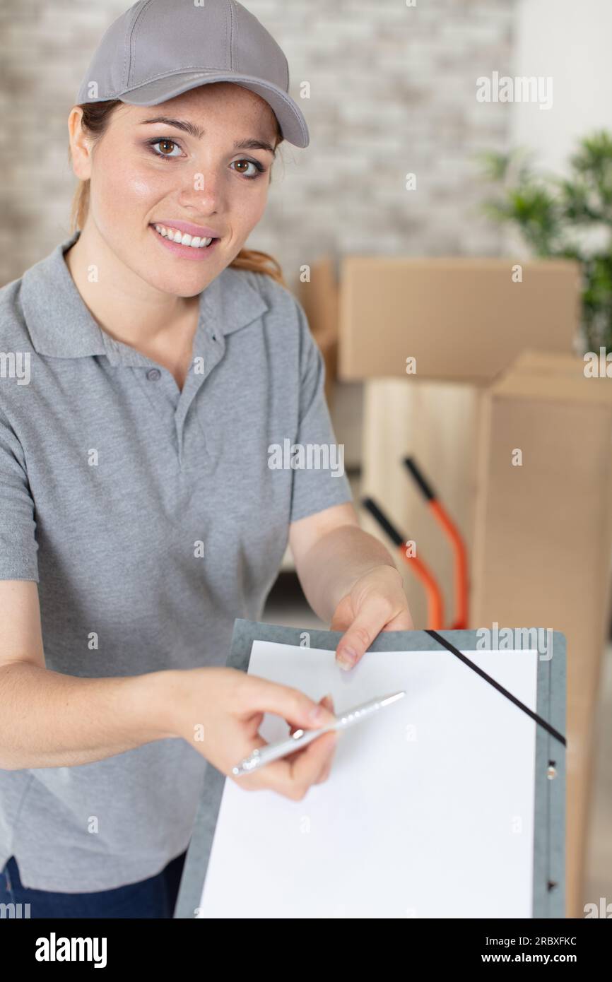 woman receiving parcels from delivery service courier indoors Stock ...