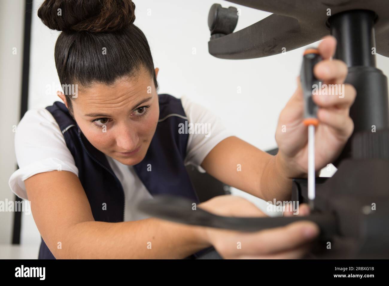 Person fixing an office chair hi-res stock photography and images - Alamy