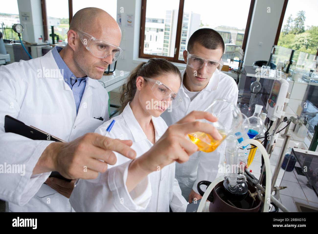 Laboratory workers experimenting different hi-res stock photography and ...
