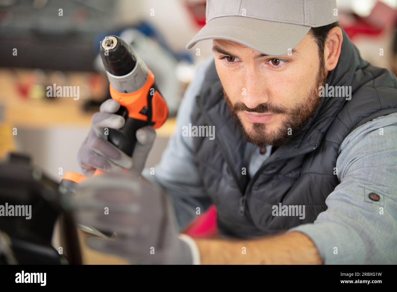 close view of tradesman using cordless drill in the workshop Stock ...