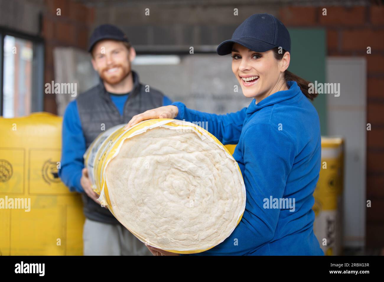 two professional builders sheathe walls with insulation Stock Photo - Alamy