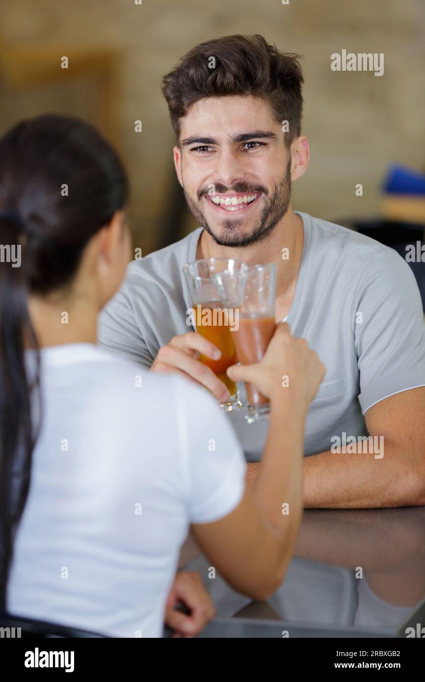 couple toasting with beers at a bar Stock Photo - Alamy