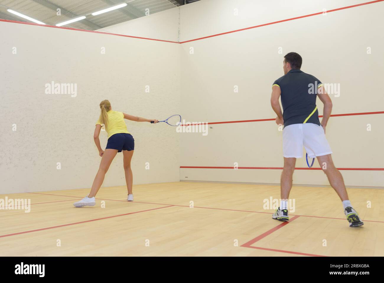 rear view of couple playing squash Stock Photo - Alamy