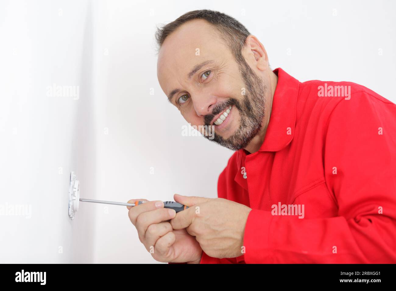 electrician mounts power plug socket Stock Photo - Alamy