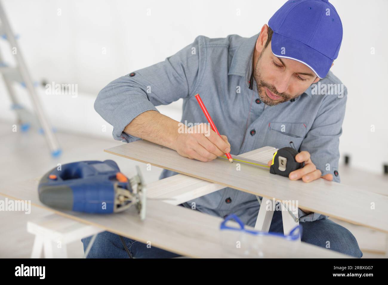 carpenter using pencil while drawing a board Stock Photo - Alamy