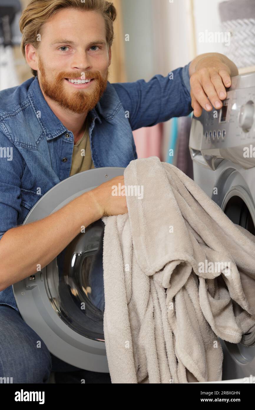 picture of man taking out cloth from washing machine Stock Photo - Alamy