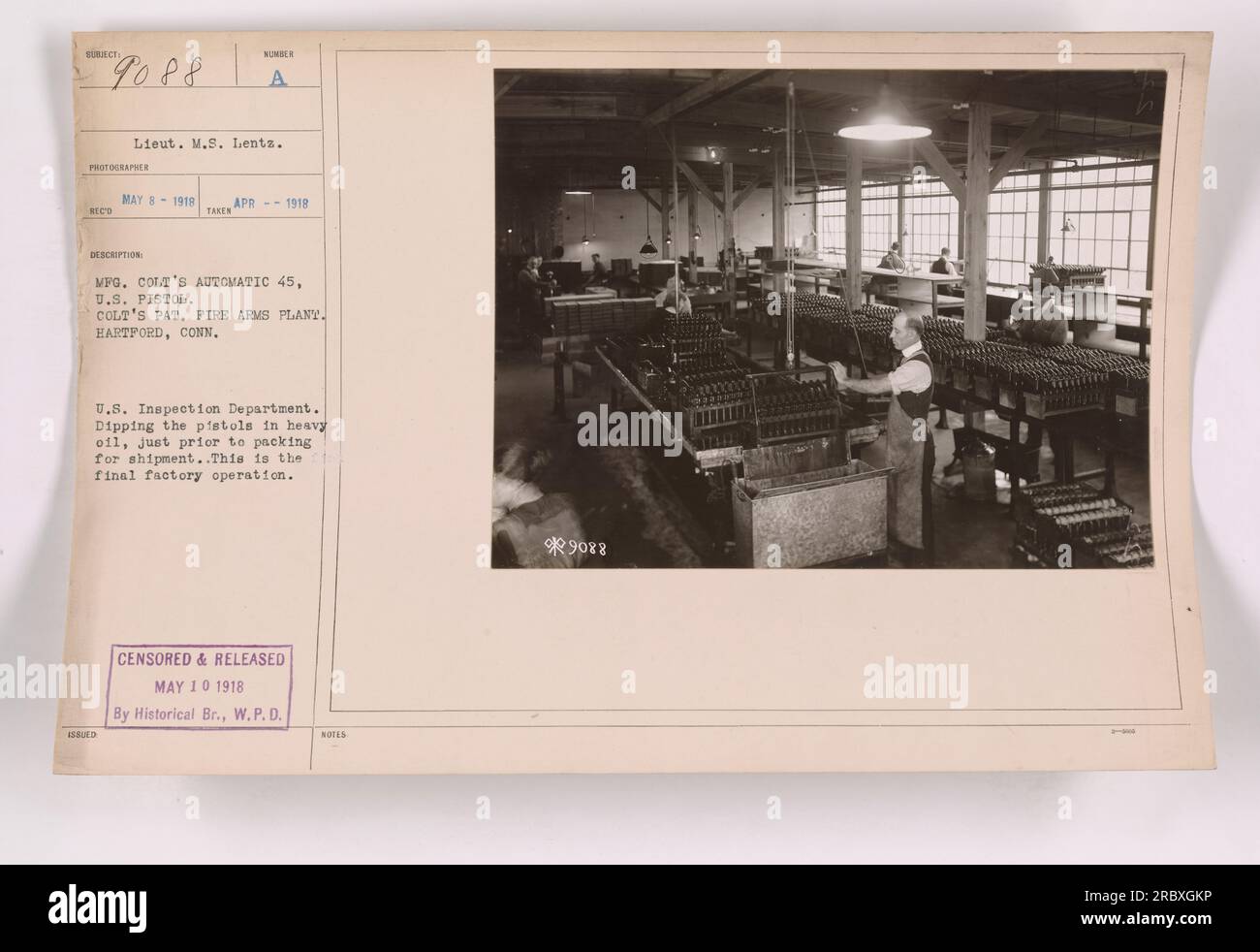 The image shows a worker at Colt's Automatic 45 factory in Hartford ...