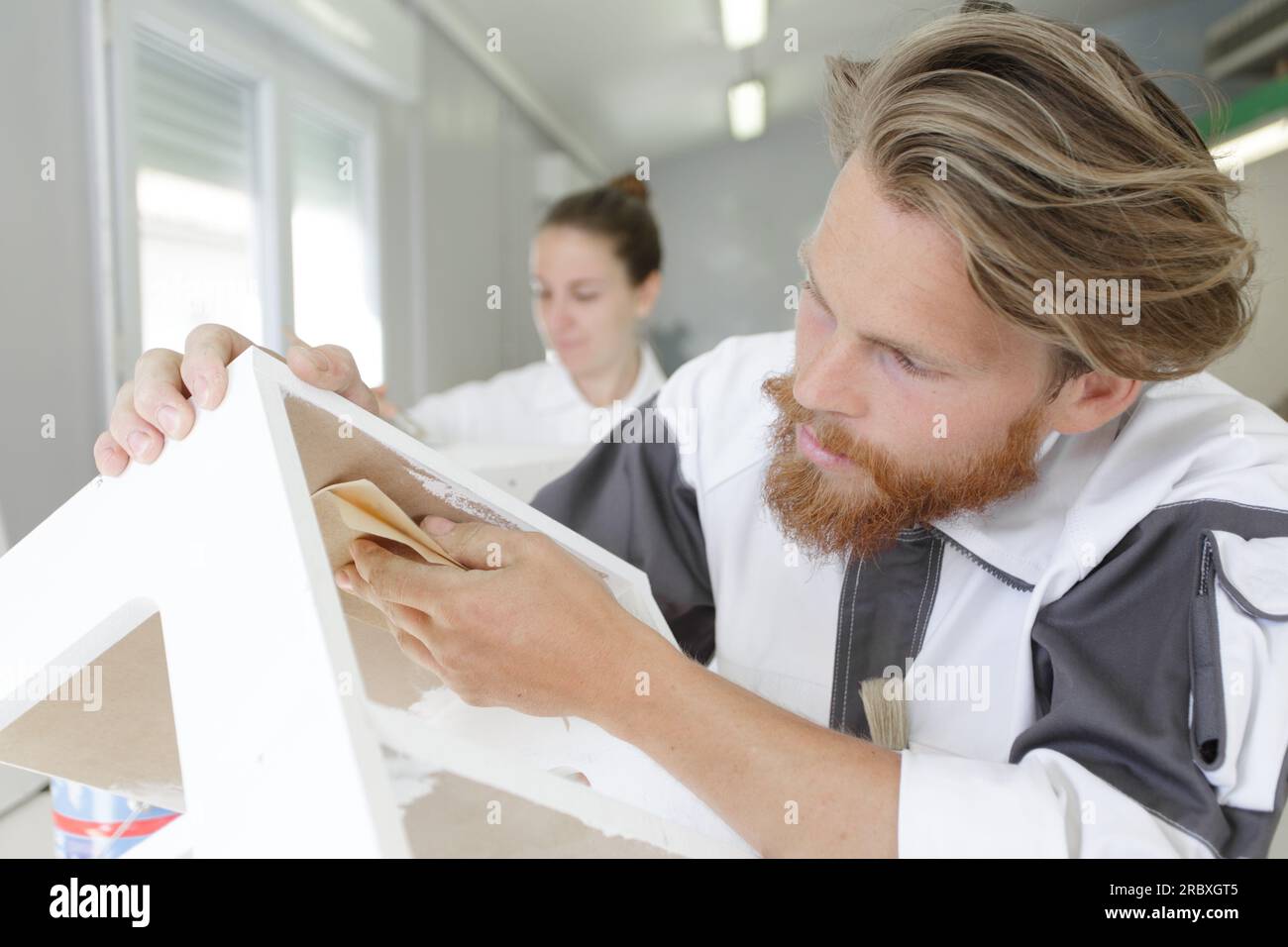 sanding and smoothing wood with black sandpaper Stock Photo - Alamy