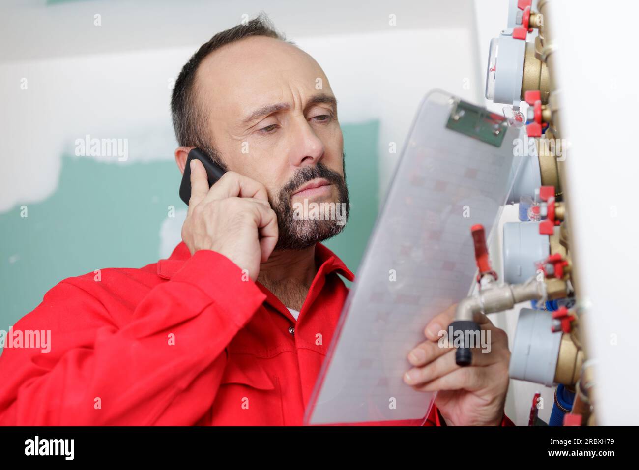 technician reading the water meter to check consumption Stock Photo - Alamy