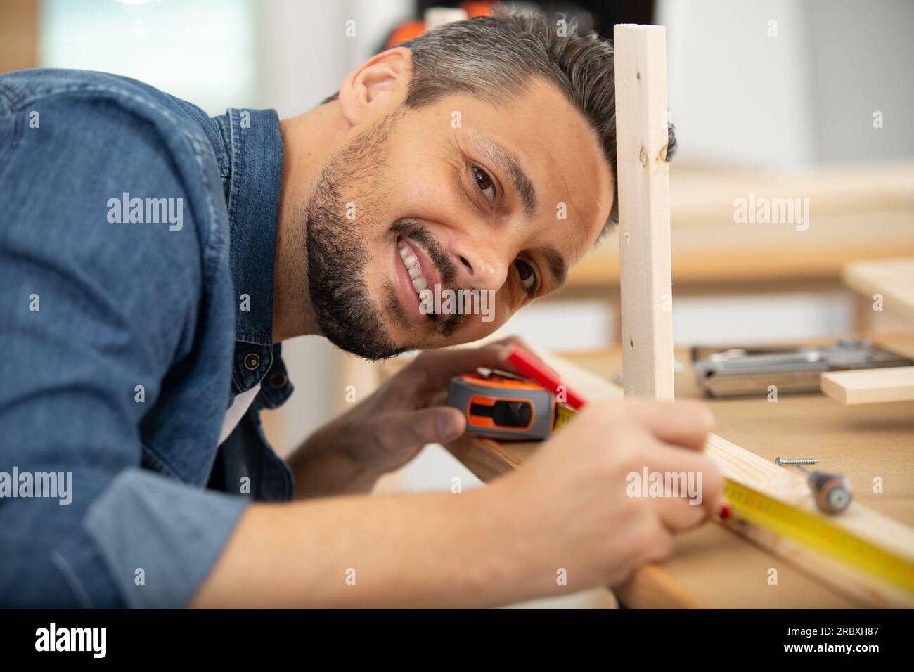 young carpenter smiling at the camera Stock Photo - Alamy