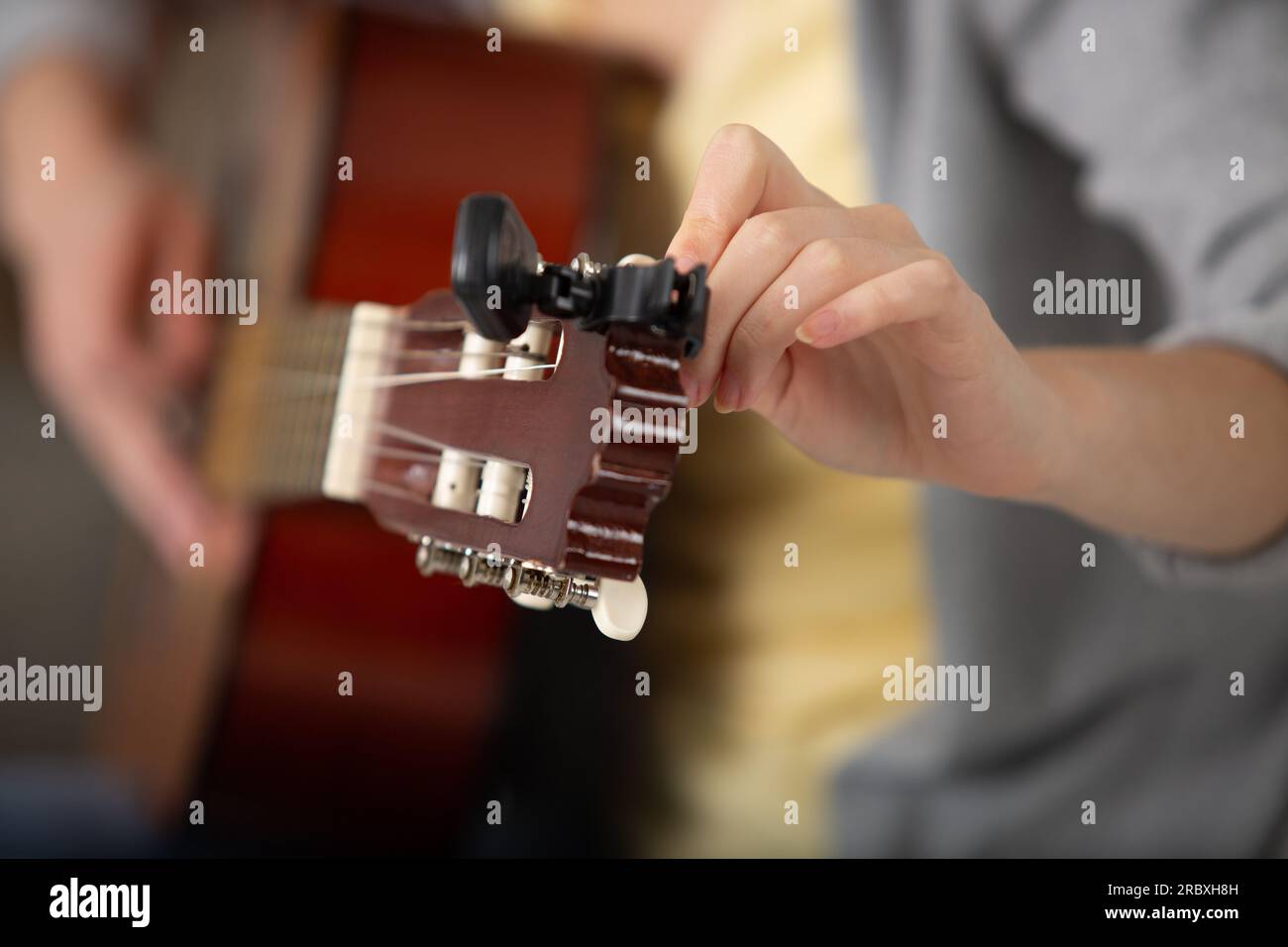 Guitar and female fingers tuning hi-res stock photography and images ...
