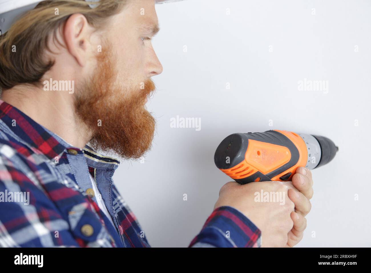 building worker with perforator drilling the wall Stock Photo - Alamy