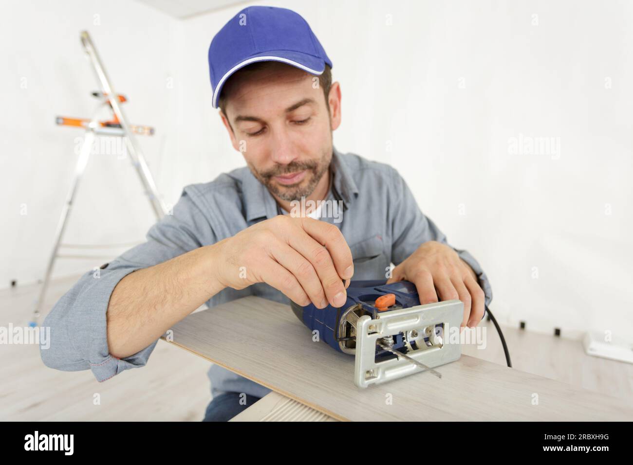 man using a table saw to cut wood Stock Photo - Alamy