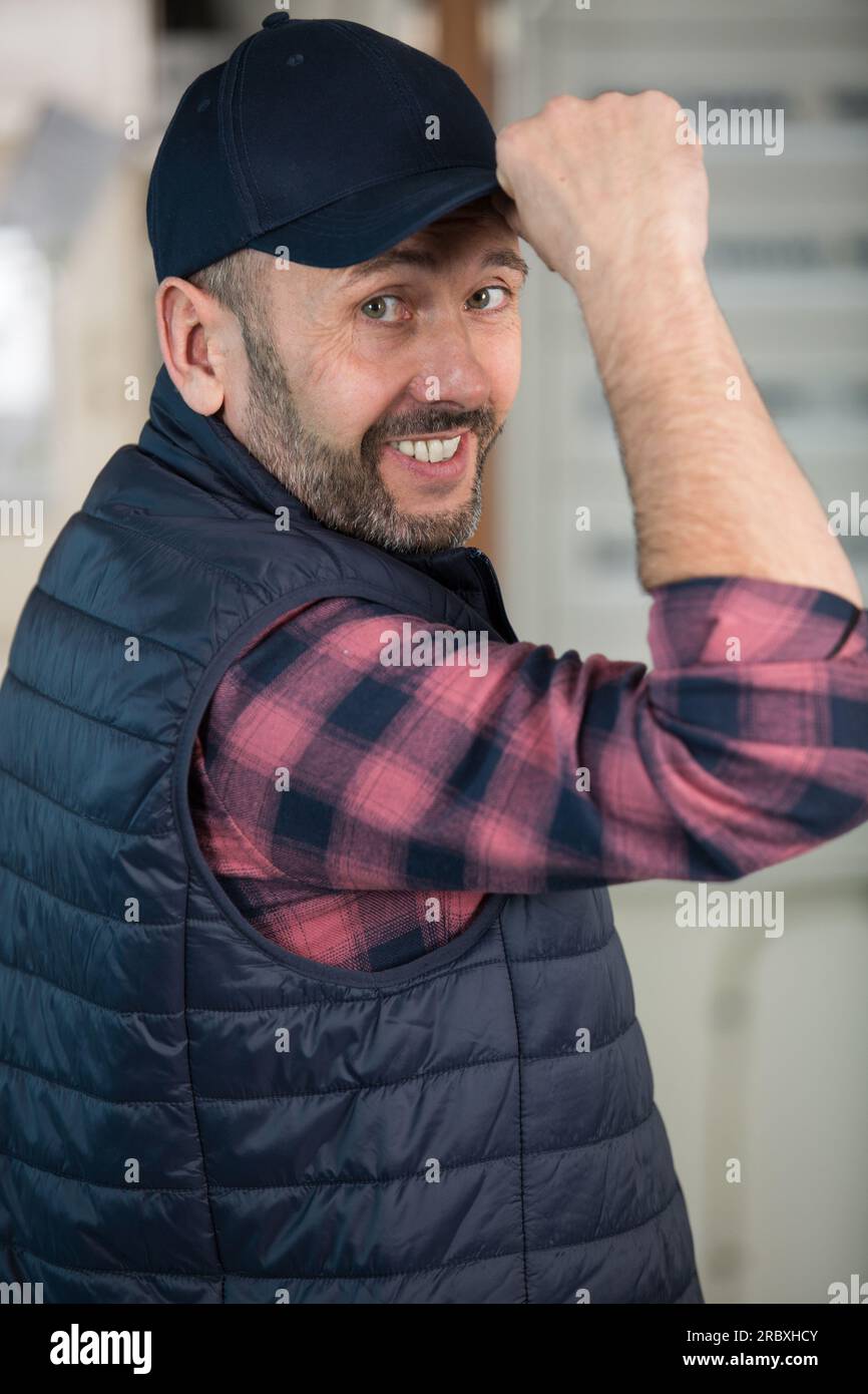 mature tradesman tipping his cap Stock Photo - Alamy