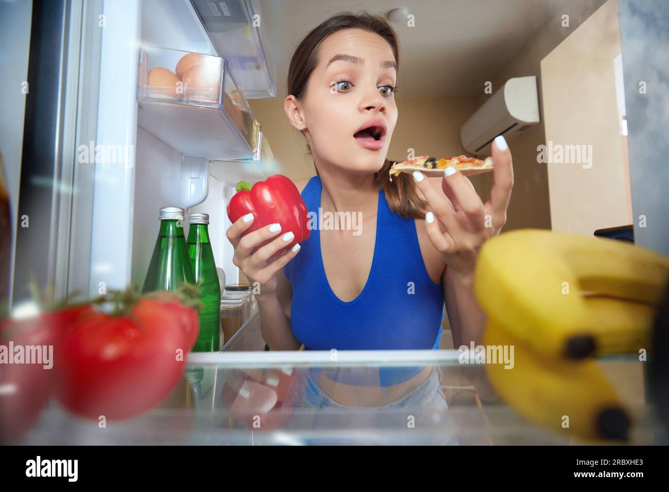 Woman opening fridge pizza hi-res stock photography and images - Alamy