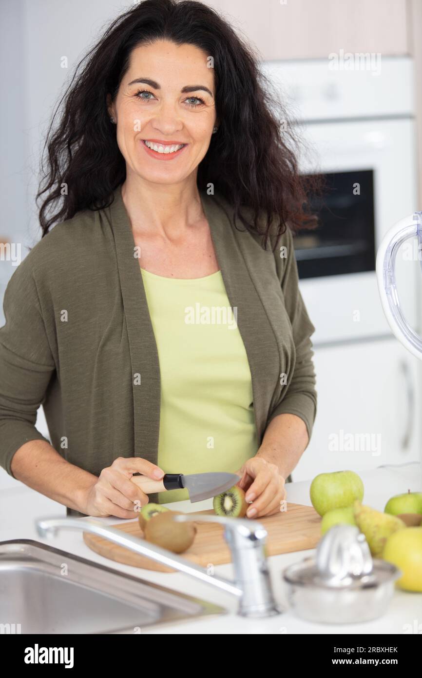 beautiful woman making fruits smoothies hen Stock Photo - Alamy