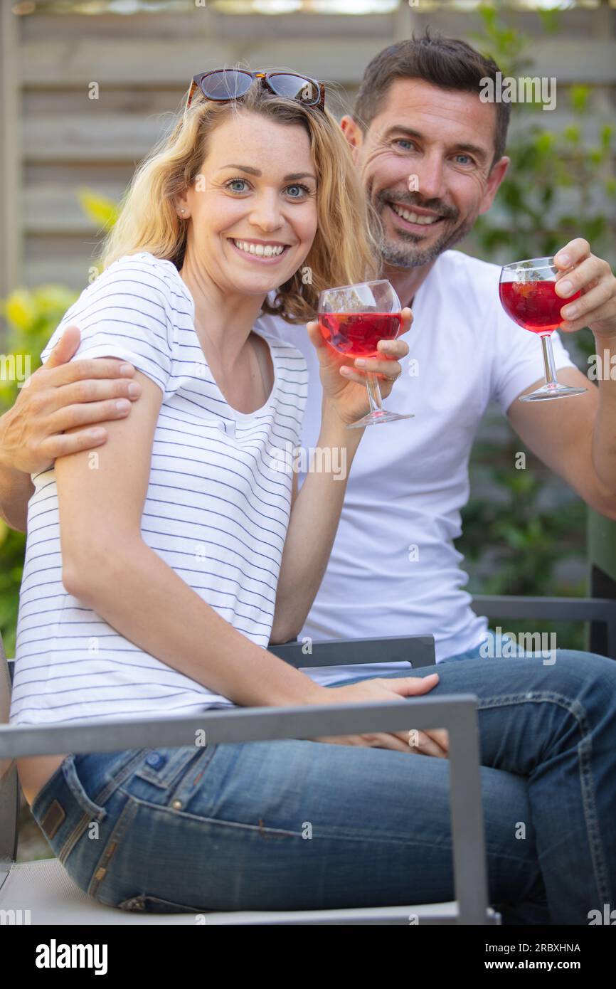 couple sitting on outdoor seat together Stock Photo - Alamy