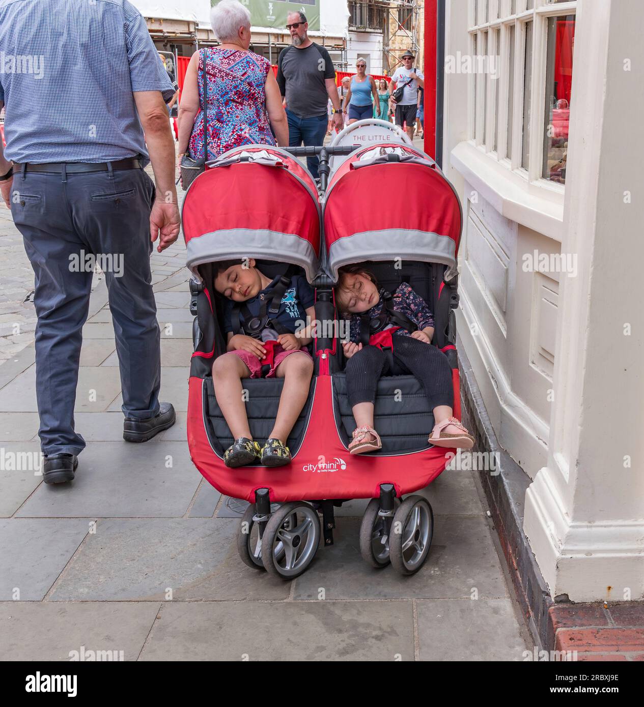 Two young children in asleep in twin pushchair, Lincoln City ...