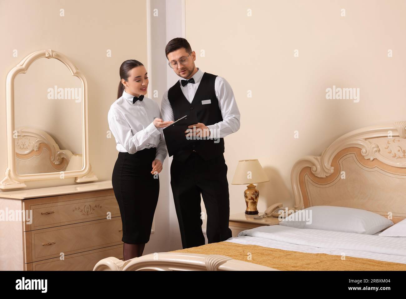 Young woman attending professional butler courses and teacher with ...