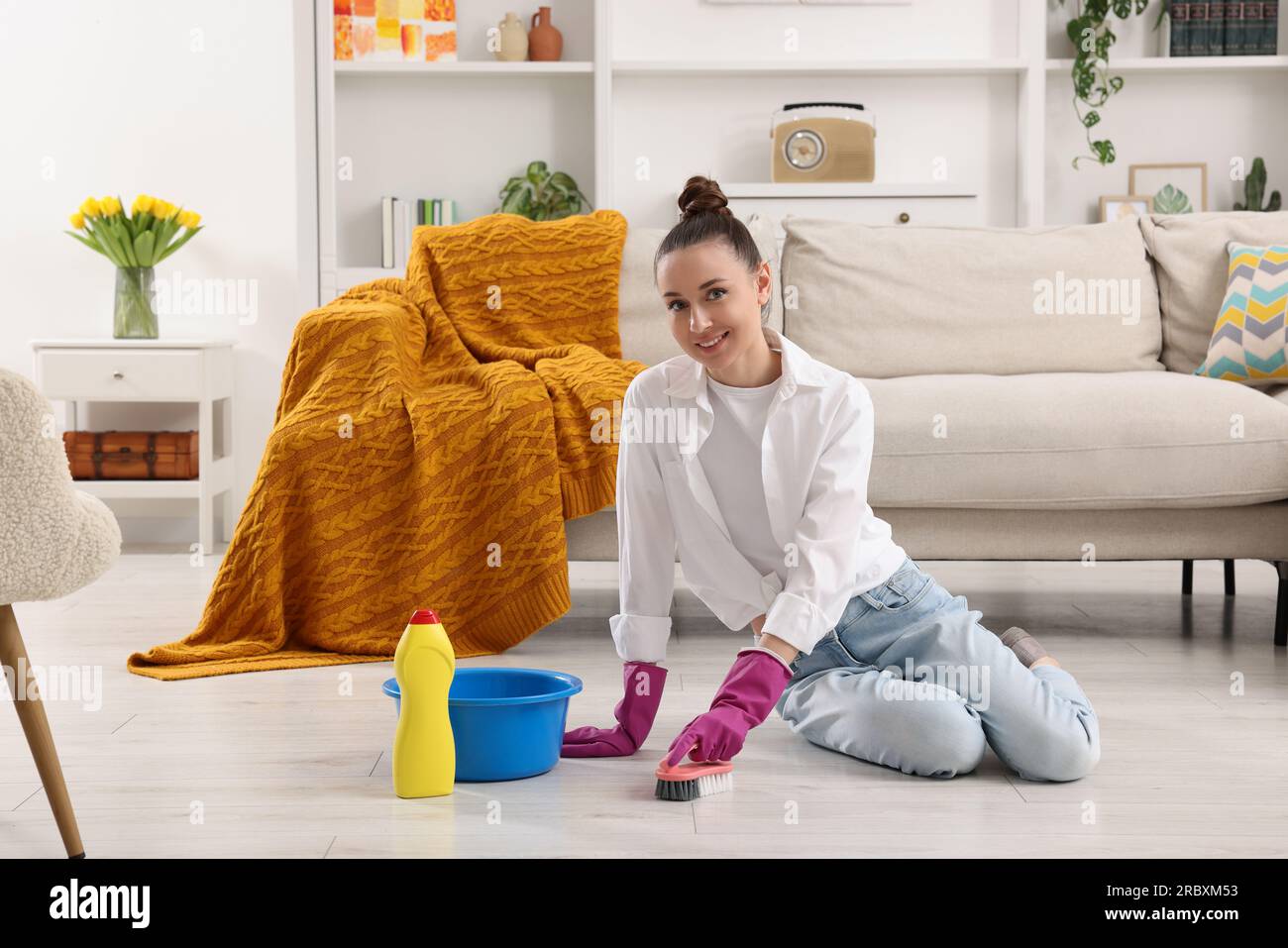 Spring cleaning. Young woman tidying up living room at home Stock Photo - Alamy