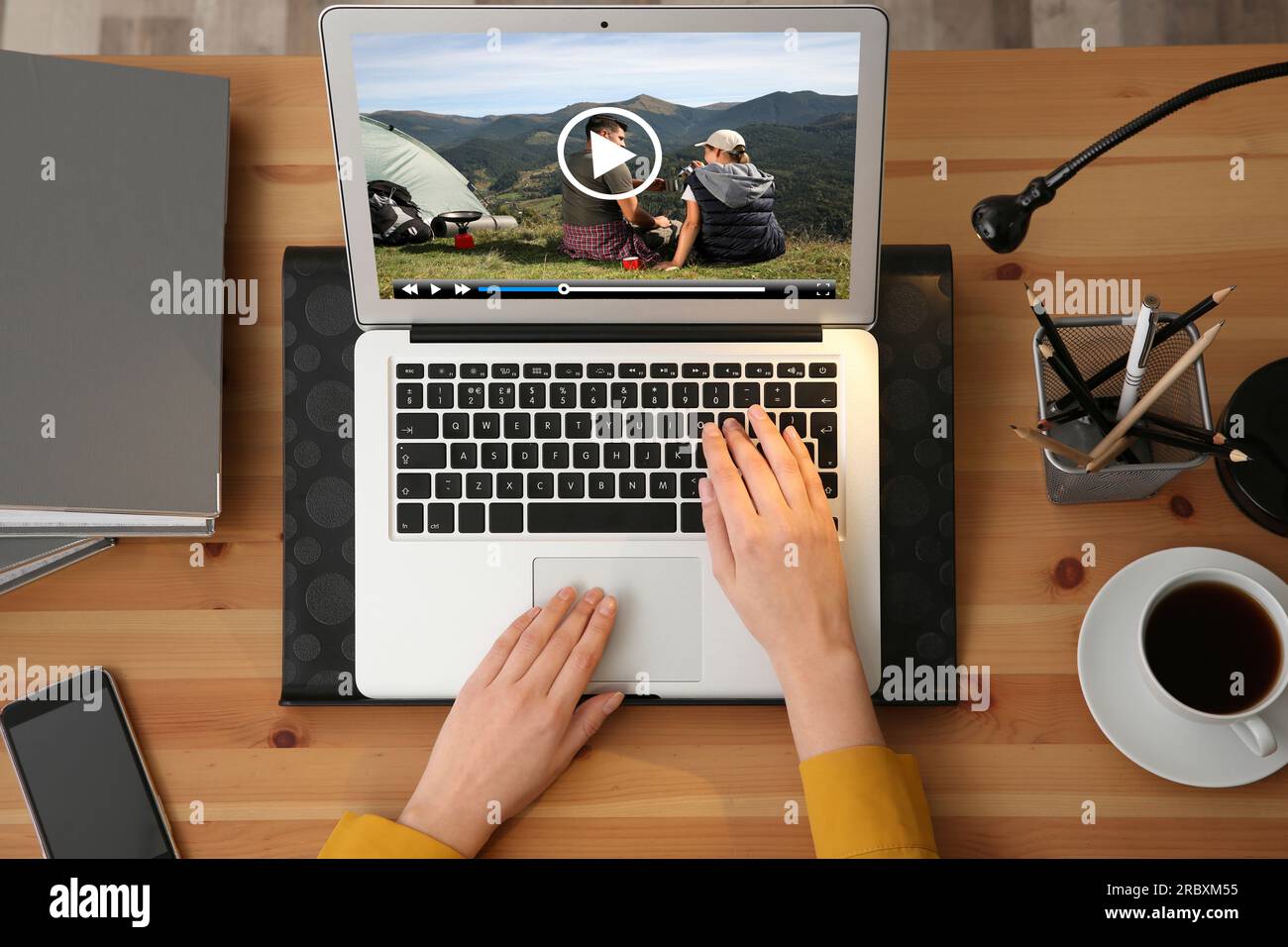Woman watching video on laptop at office desk, closeup. Top view Stock ...