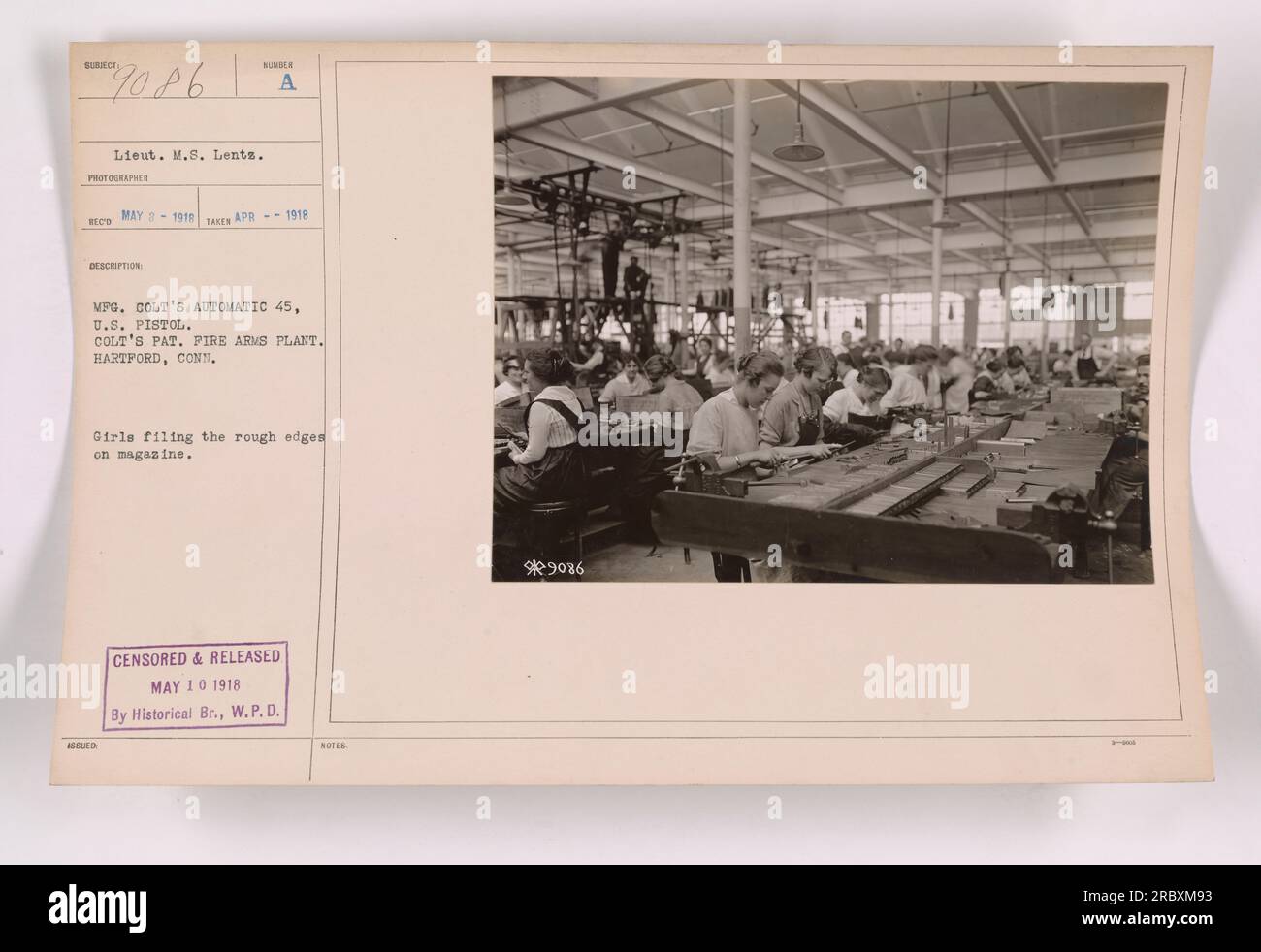 Lieutenant M.S. Lents captured this photograph titled "Girls filing the rough edges on the ...
