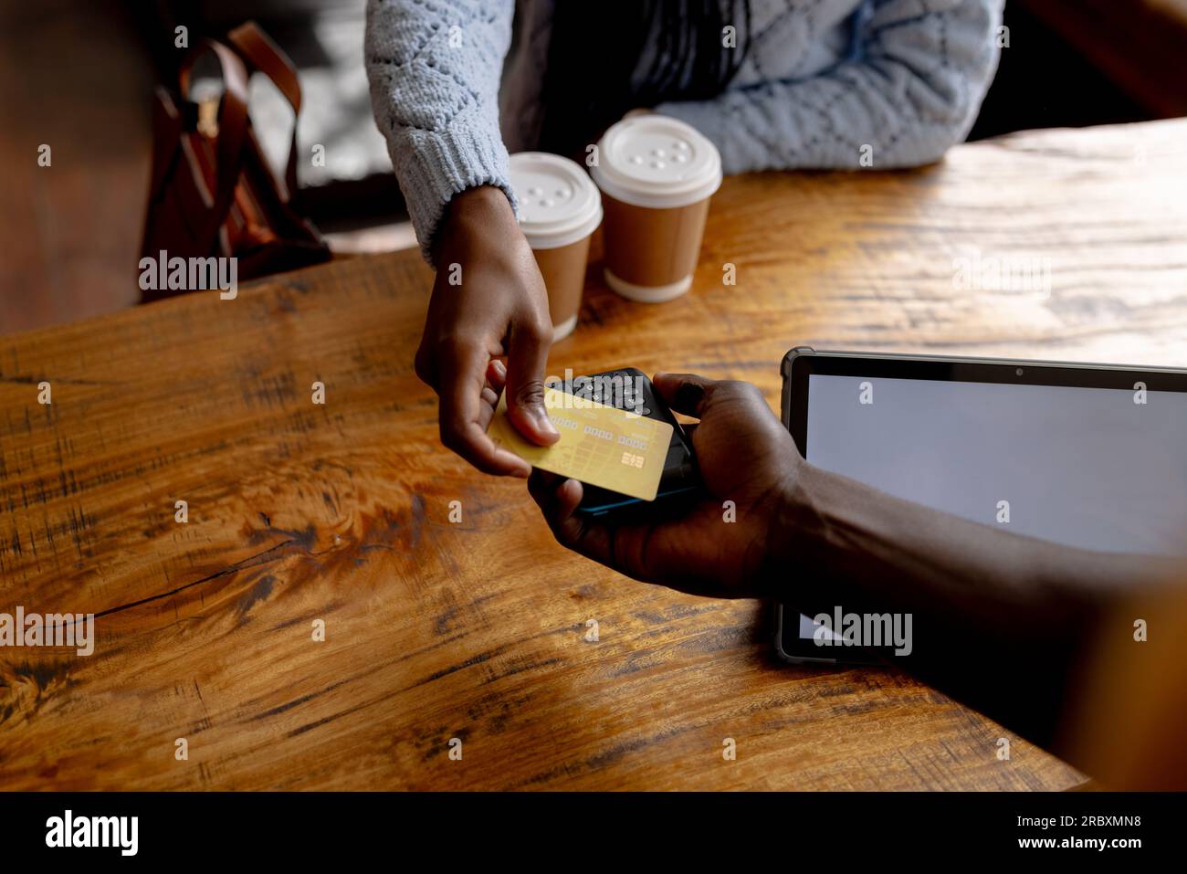 Hand of african american woman paying with credit card in cafe Stock ...