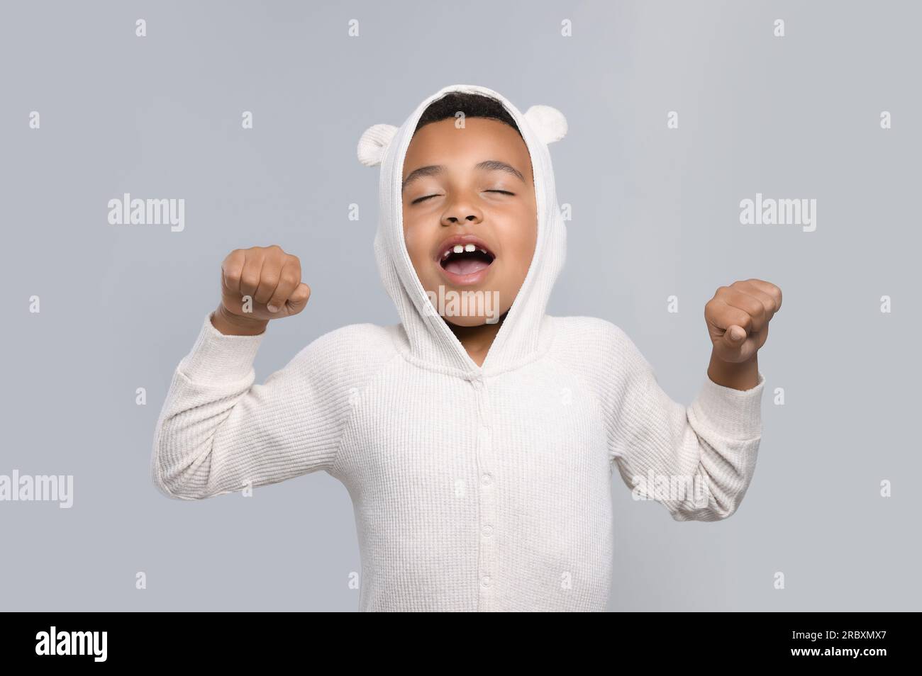 Boy yawning and stretching on grey background. Insomnia problem Stock ...