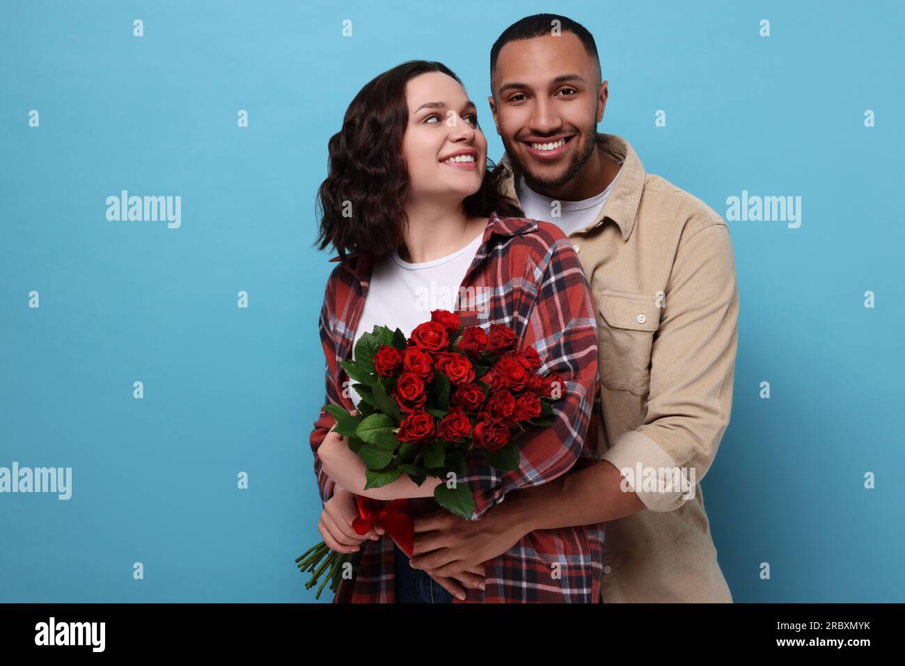 Happy couple celebrating Valentine's day. Beloved woman with bouquet of ...