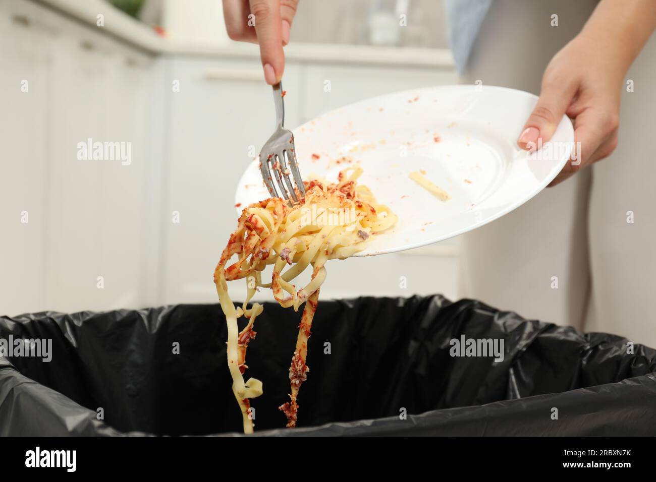 Woman throwing plate of food bin hi-res stock photography and images ...