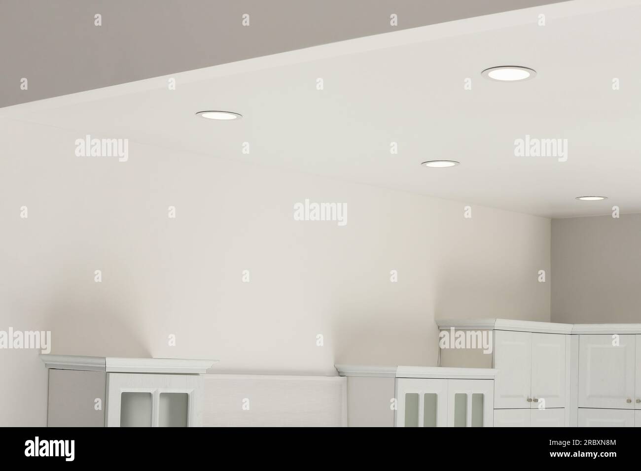 White ceiling with modern lighting in room Stock Photo - Alamy