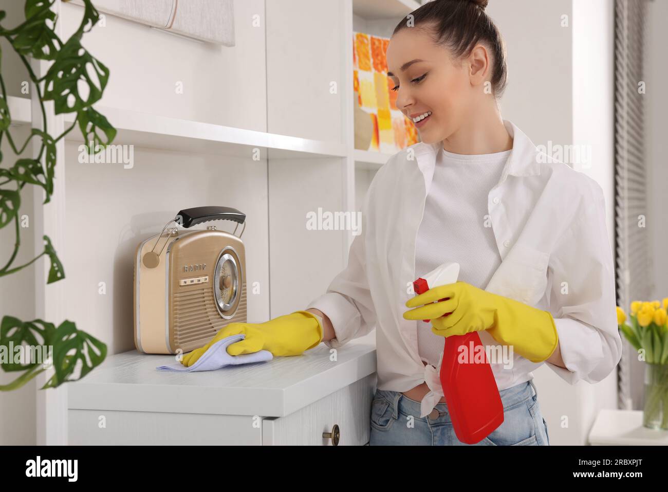 Woman tidying up room hi-res stock photography and images - Alamy