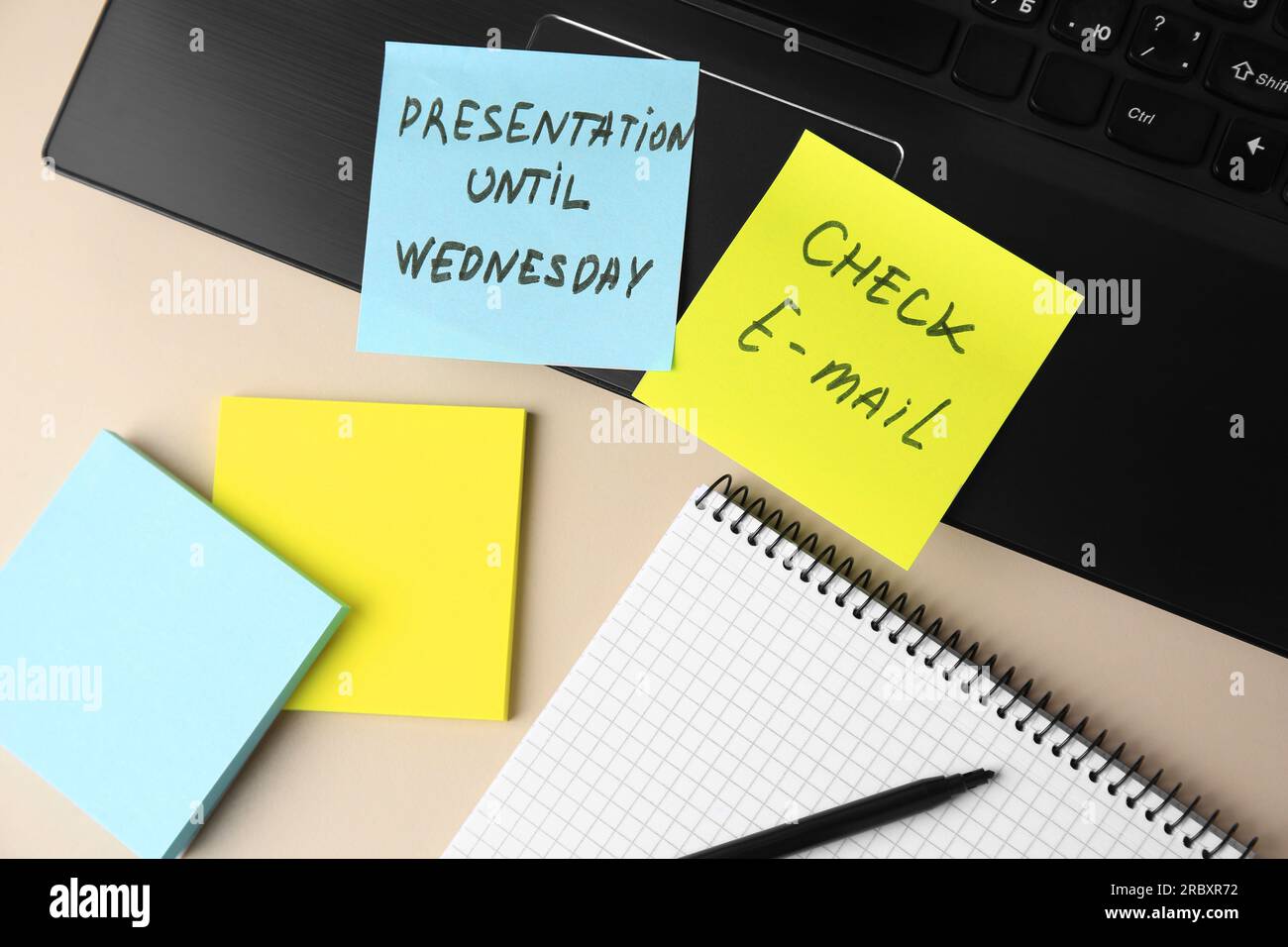 Laptop with reminder notes and notebook on beige desk, flat lay Stock ...