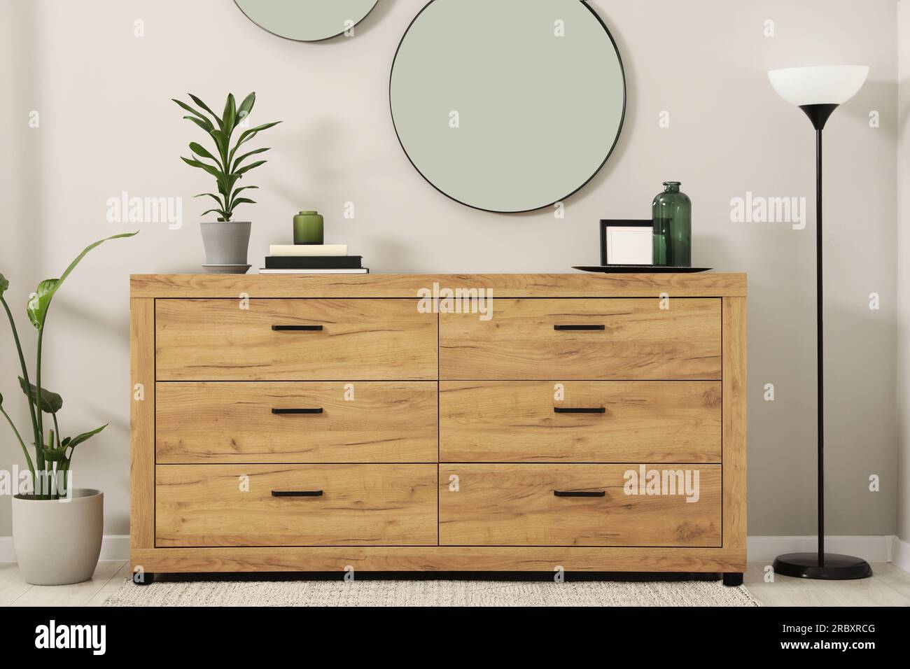 Cozy room interior with chest of drawers, mirrors and decor elements ...