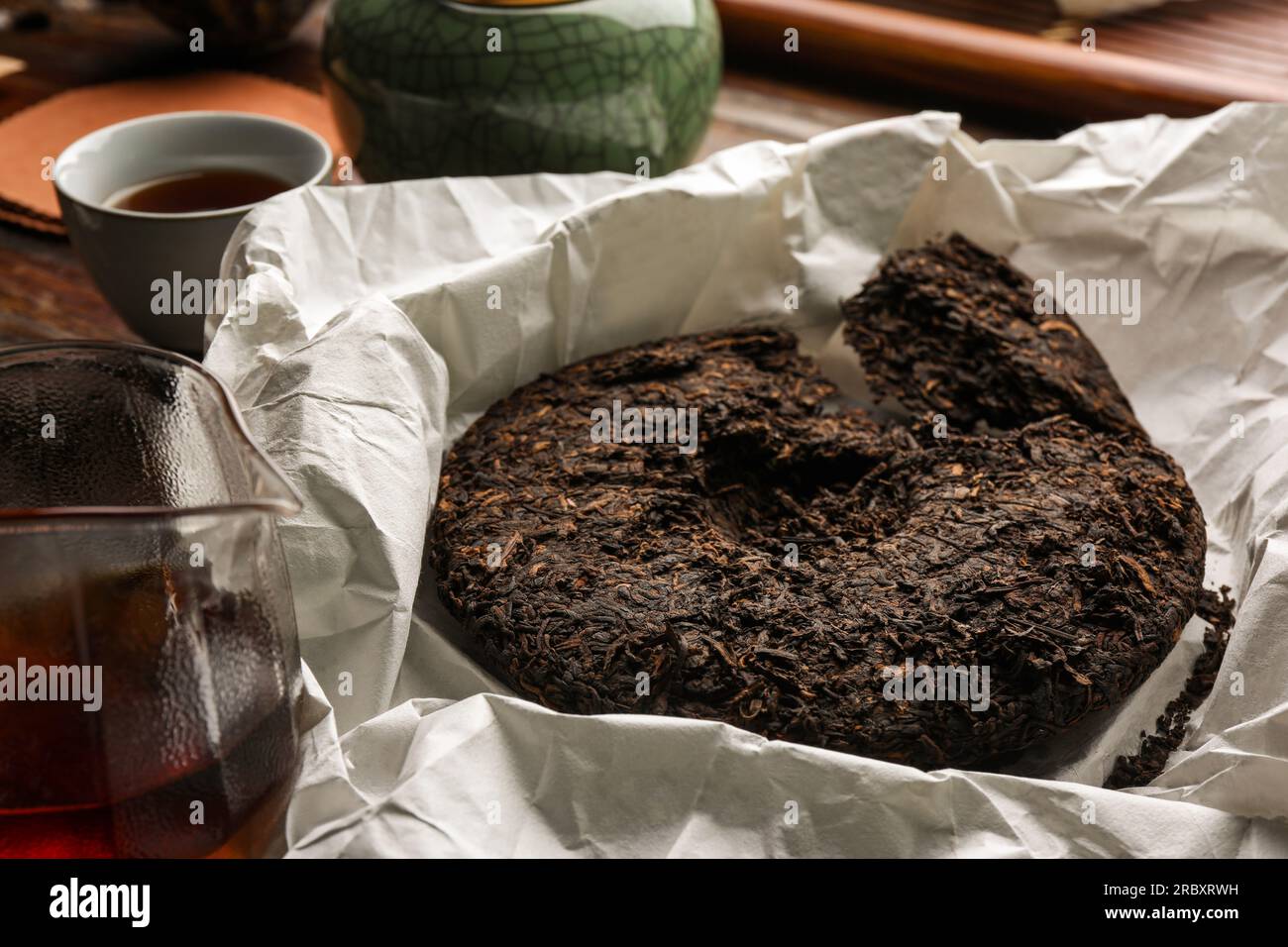 Broken disc shaped pu-erh tea on parchment paper Stock Photo - Alamy
