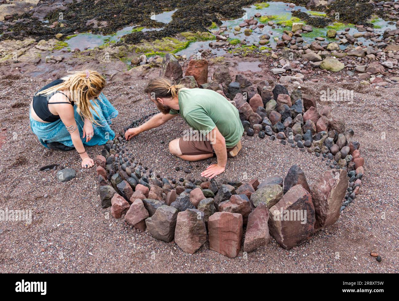 Land artist Jon Foreman creates a rock or stone sculpture, European ...