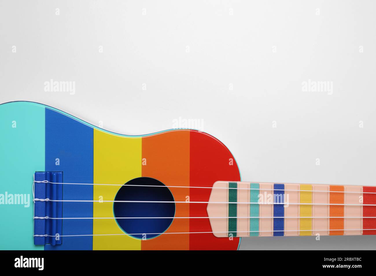 Colorful ukulele on white background, top view with space for text ...