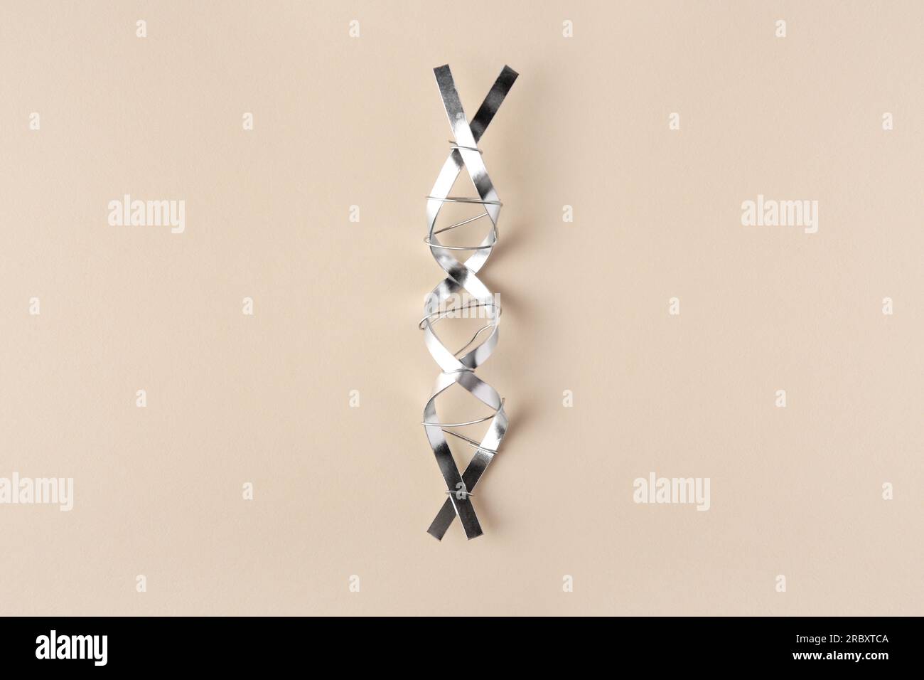 DNA molecular chain model made of metal on beige background, top view ...