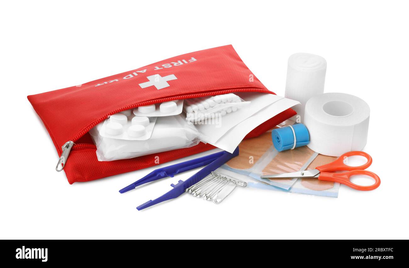 Red first aid kit with scissors, pins, cotton buds, pills, plastic ...
