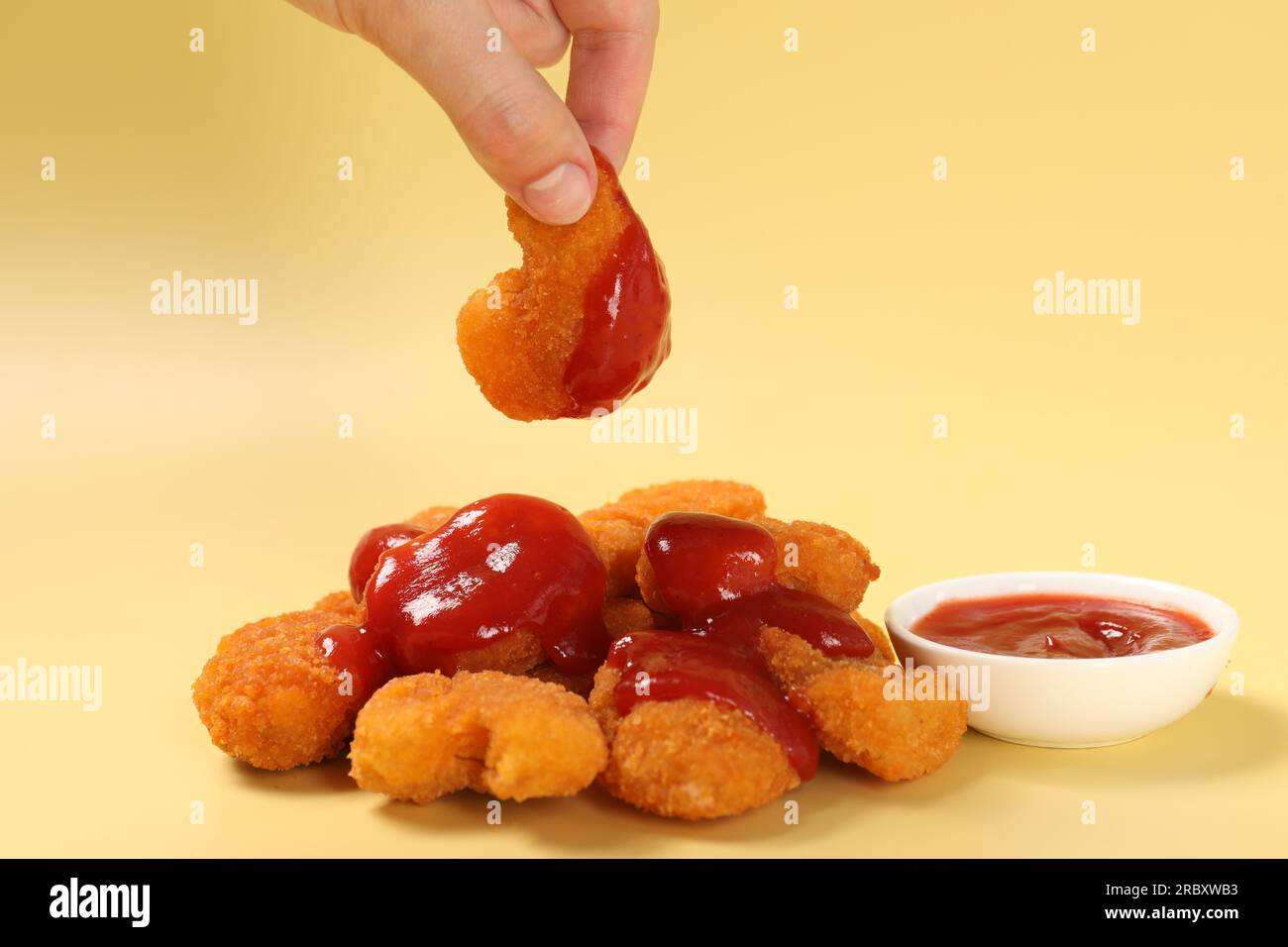 Person eating chicken nuggets hi-res stock photography and images - Alamy