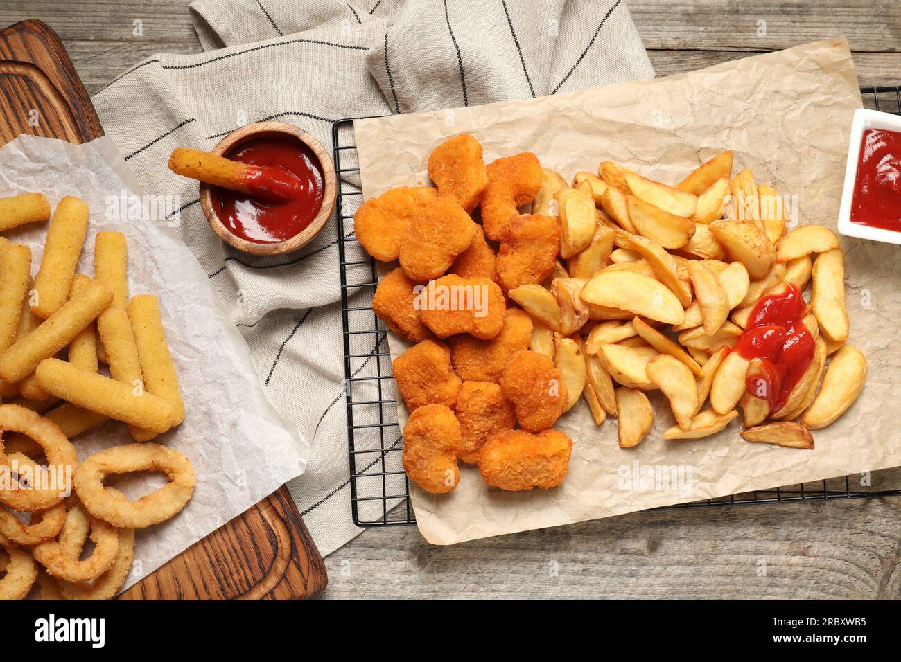 Different snacks and tasty ketchup on table, flat lay Stock Photo - Alamy