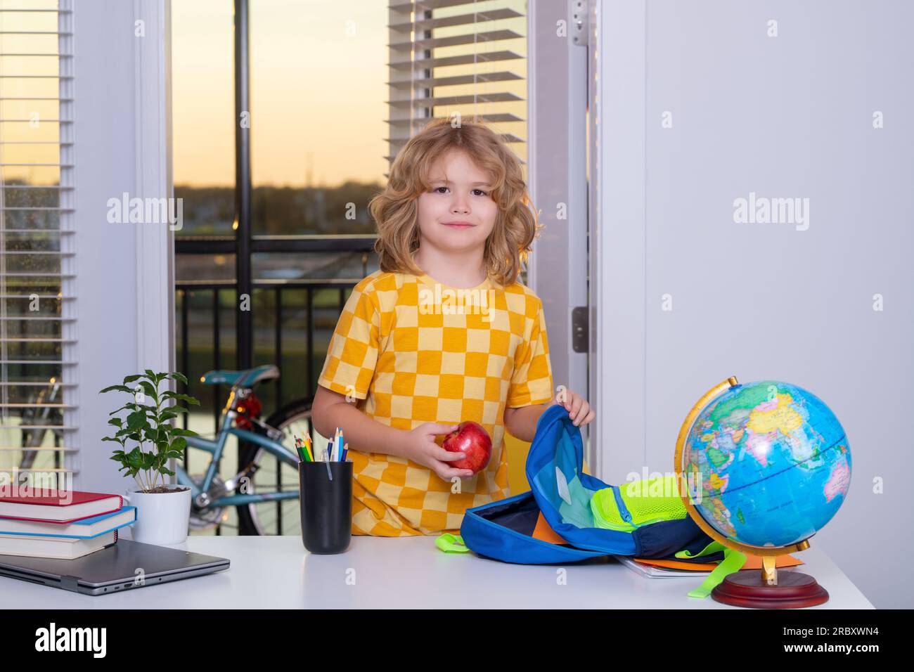 Nerd pupil doing homework puts school supplies in a backpack. Clever ...