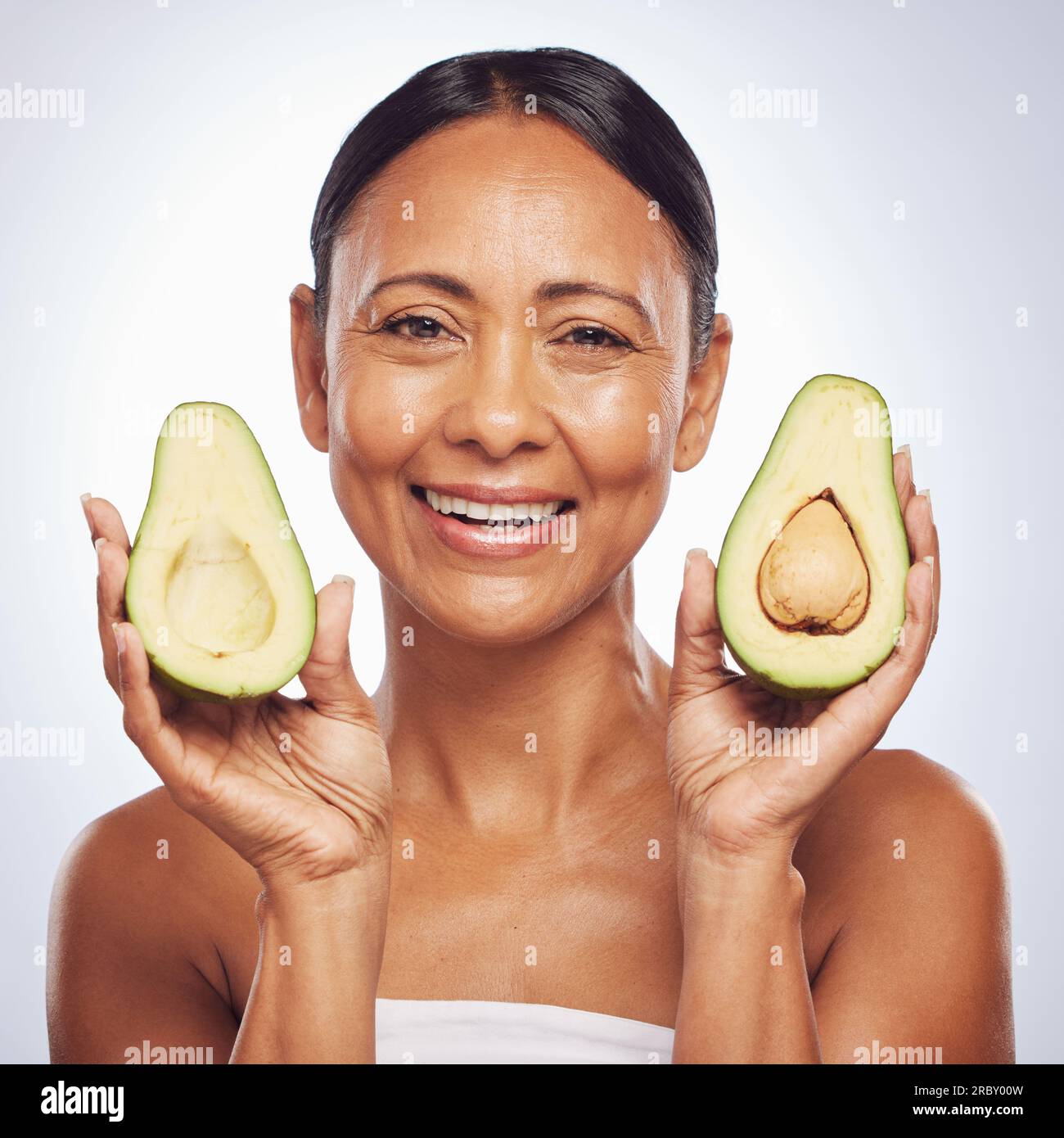 Avocado, portrait and beauty of woman in studio, white background and ...