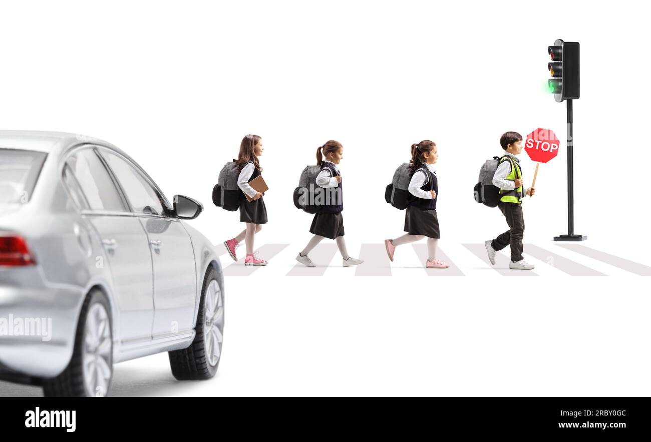 Full length profile shot of a group of children crossing street and ...