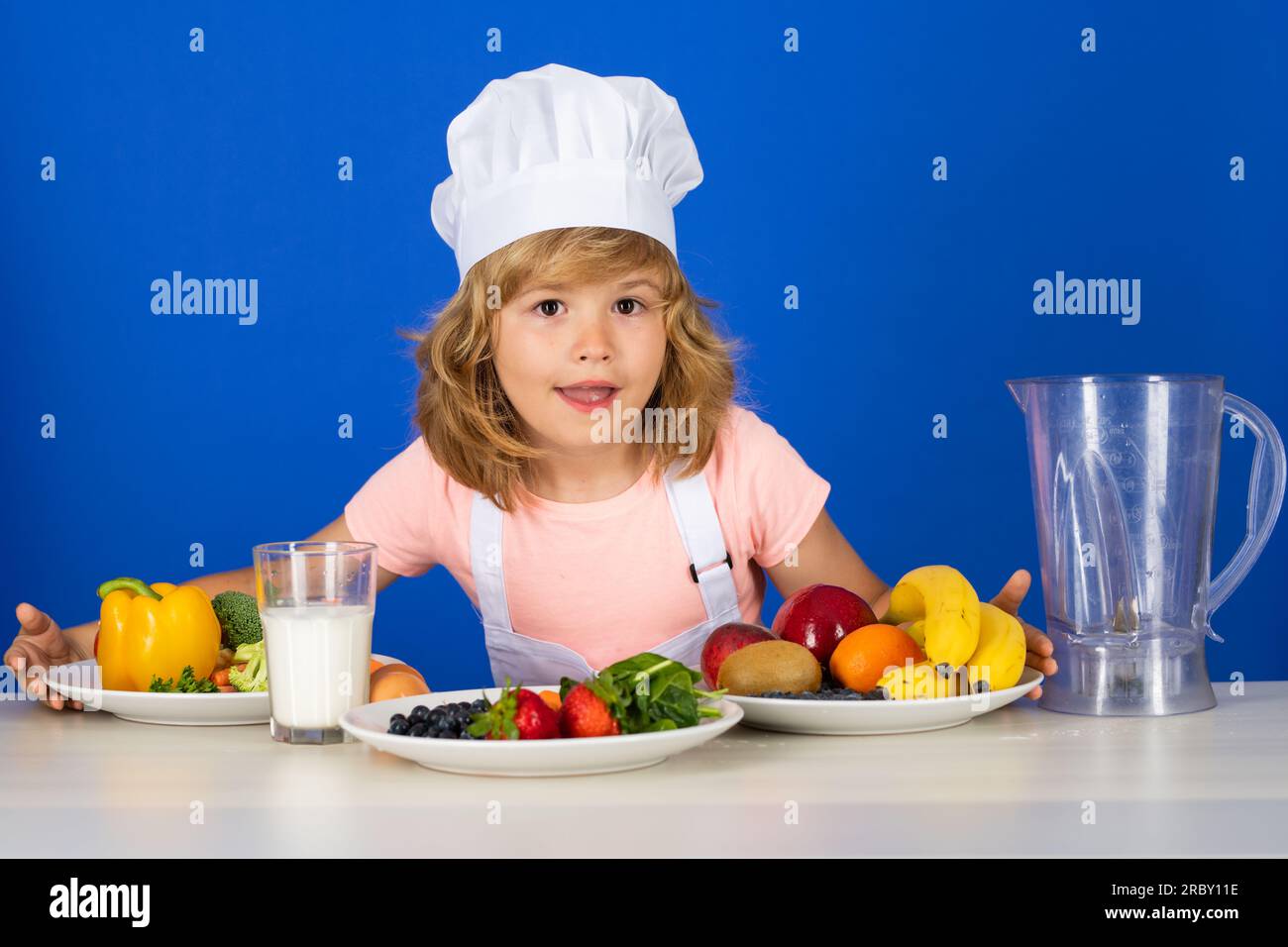 Fruits and vegetables for kids. Child chef isolated on blue. Funny ...
