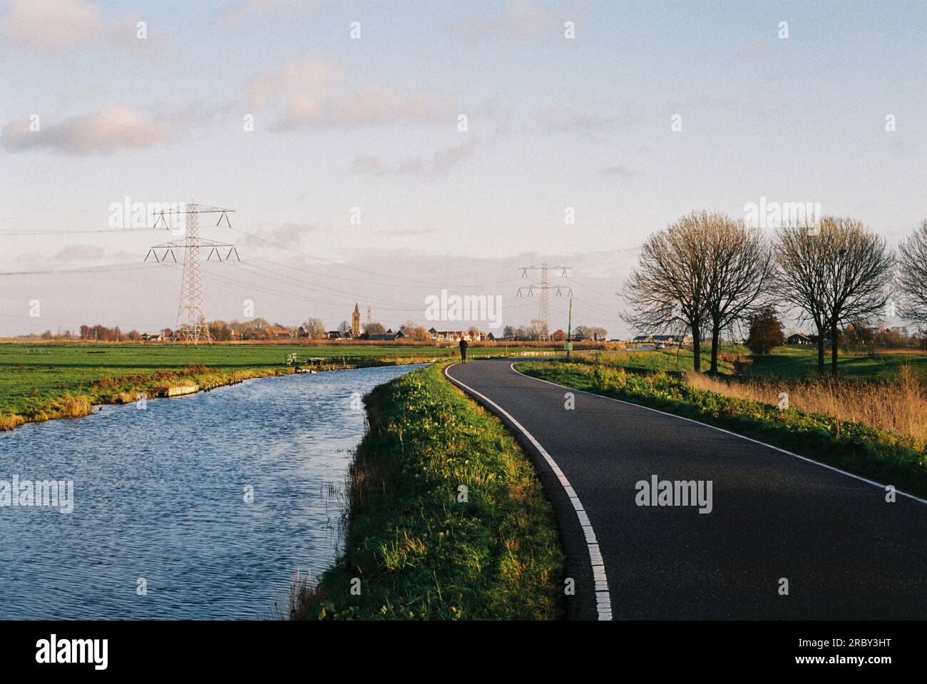 asphalt road in the dutch countryside with a canal on the side Stock ...