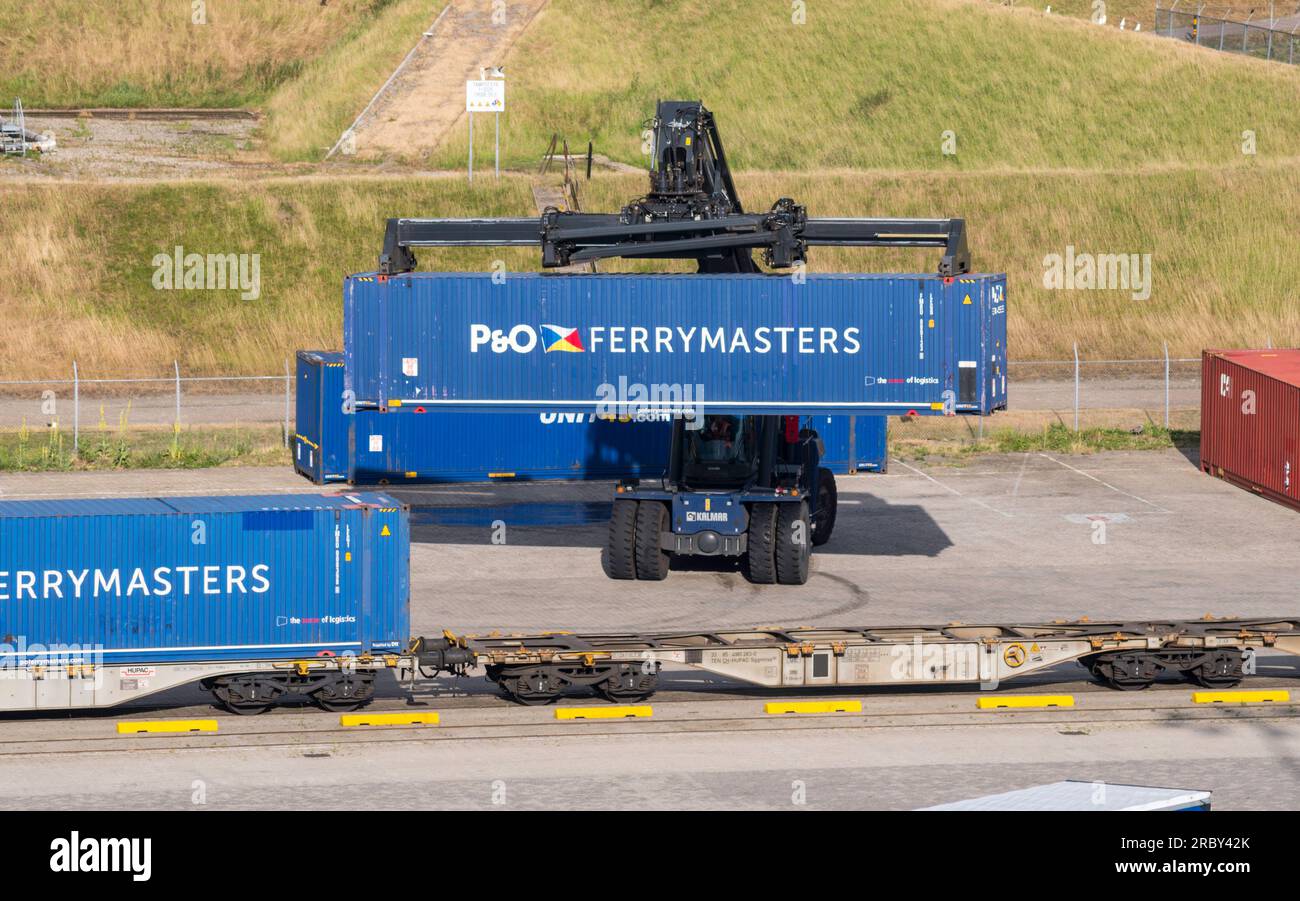 P&O Ferrymasters shipping container being loaded onto a railway truck ...