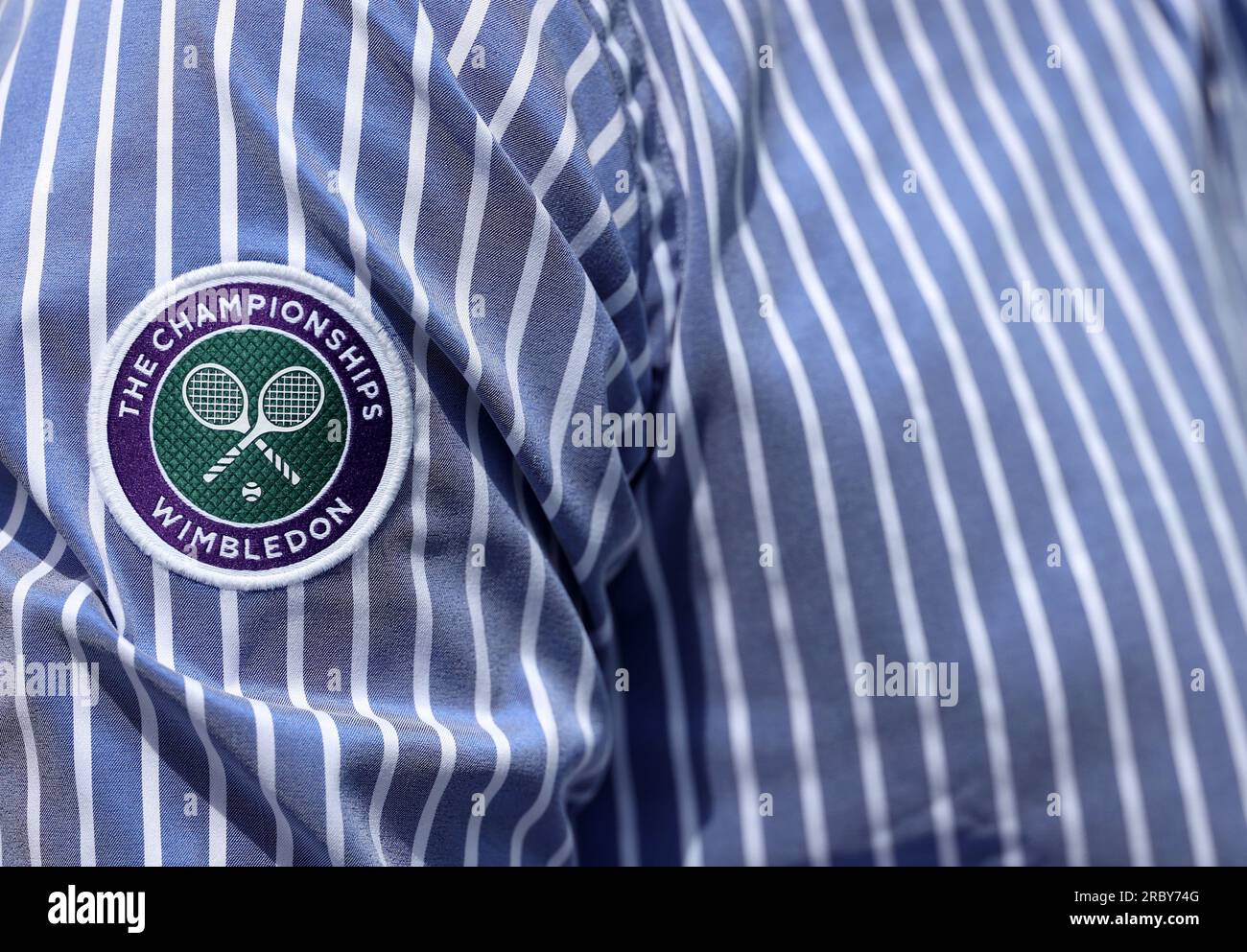 A detailed view of a Wimbledon logo on the shirt of an official on day ...